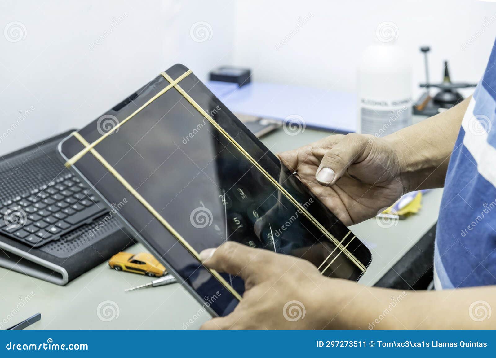 A Technician Repairing the Screen of a Large, Thin Tablet in His ...