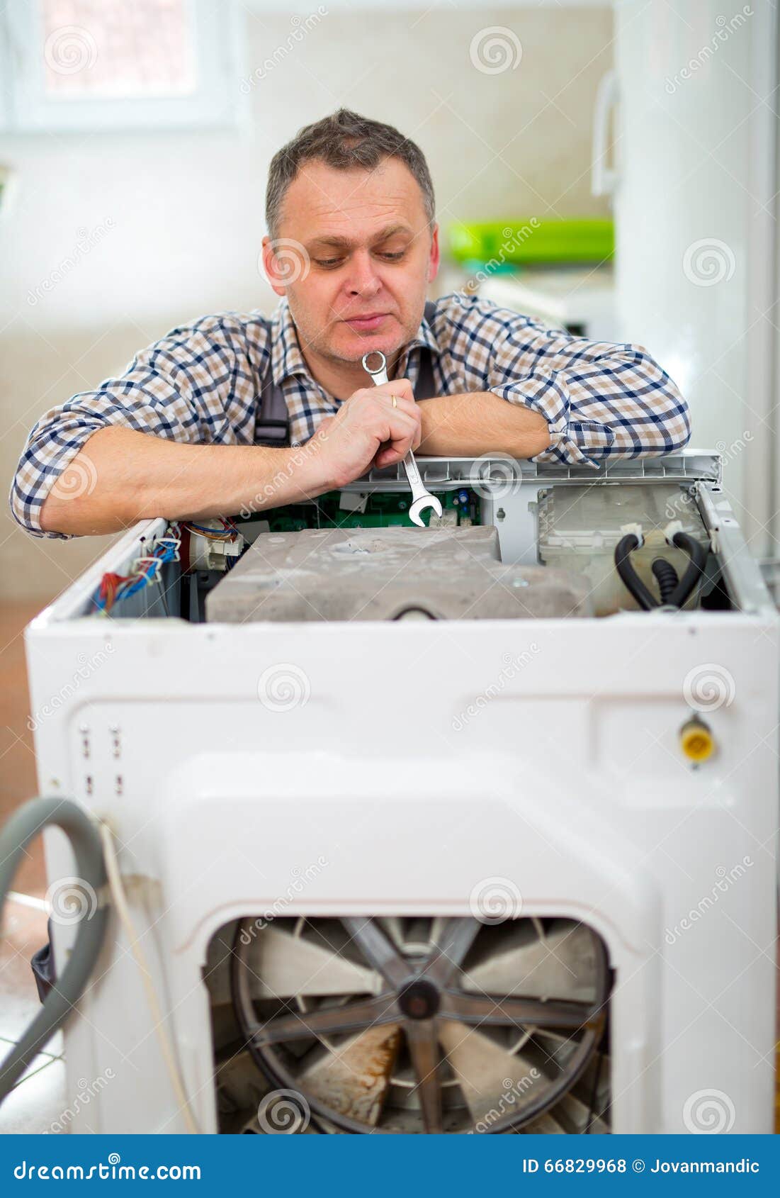 Technician Repairing a Washing Machine Stock Photo - Image of male ...