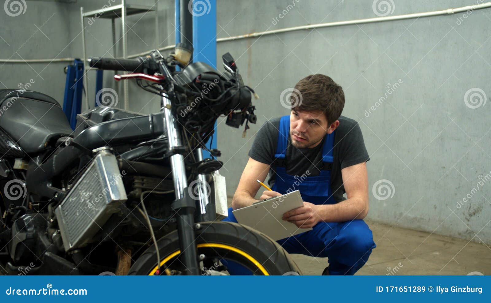 Technician Repairs a Motorcycle and Takes Notes Stock Image - Image of ...