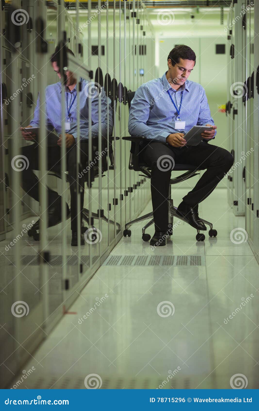 Technician Siting on Chair and Using Digital Tablet Stock Photo - Image ...