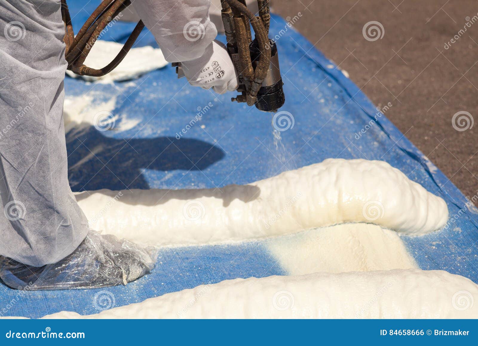 Technician Spraying Foam Insulation Using Plural Component Spray Gun ...