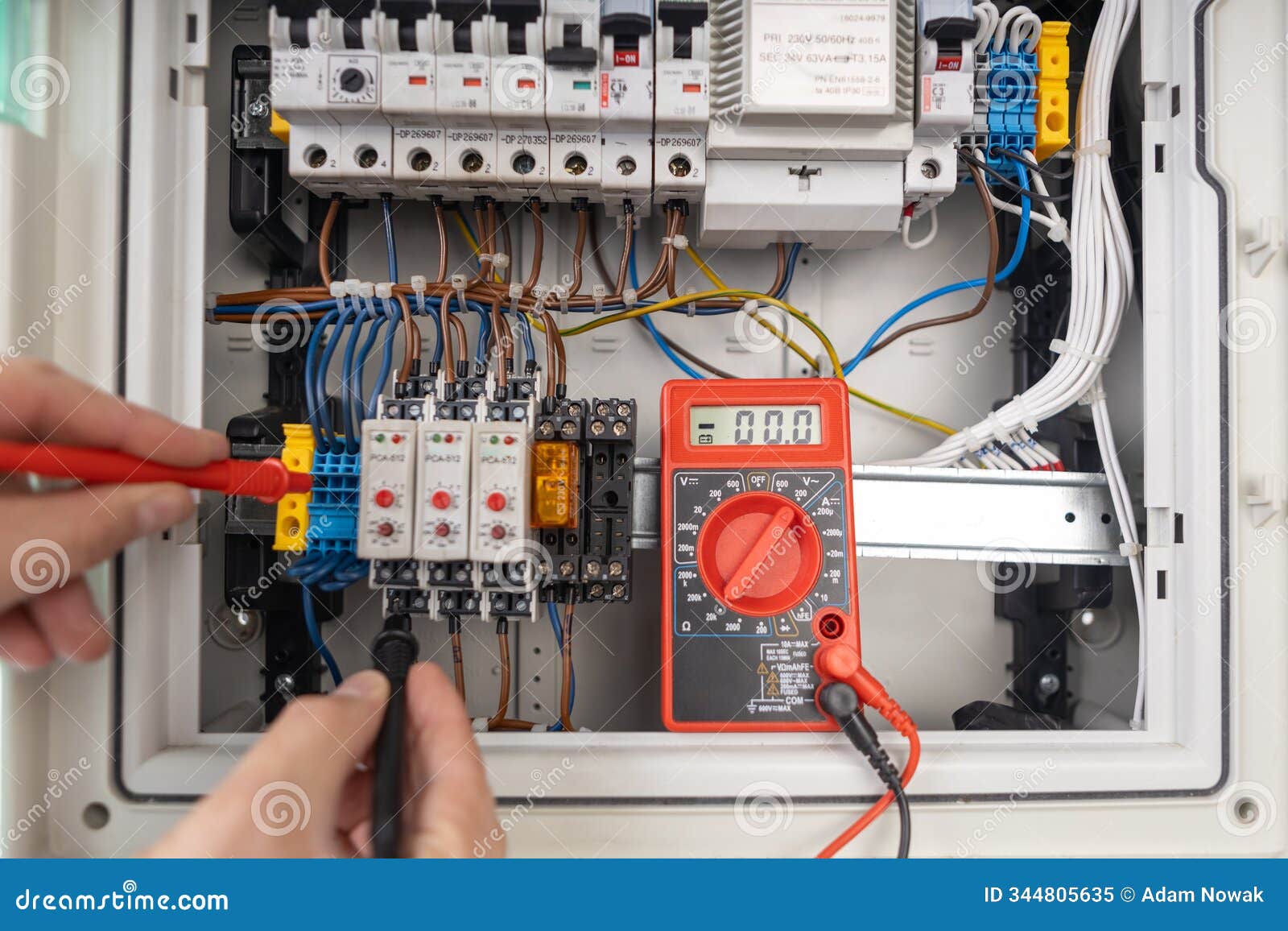 Technician Testing Electrical Circuit Board with Multimeter Stock ...