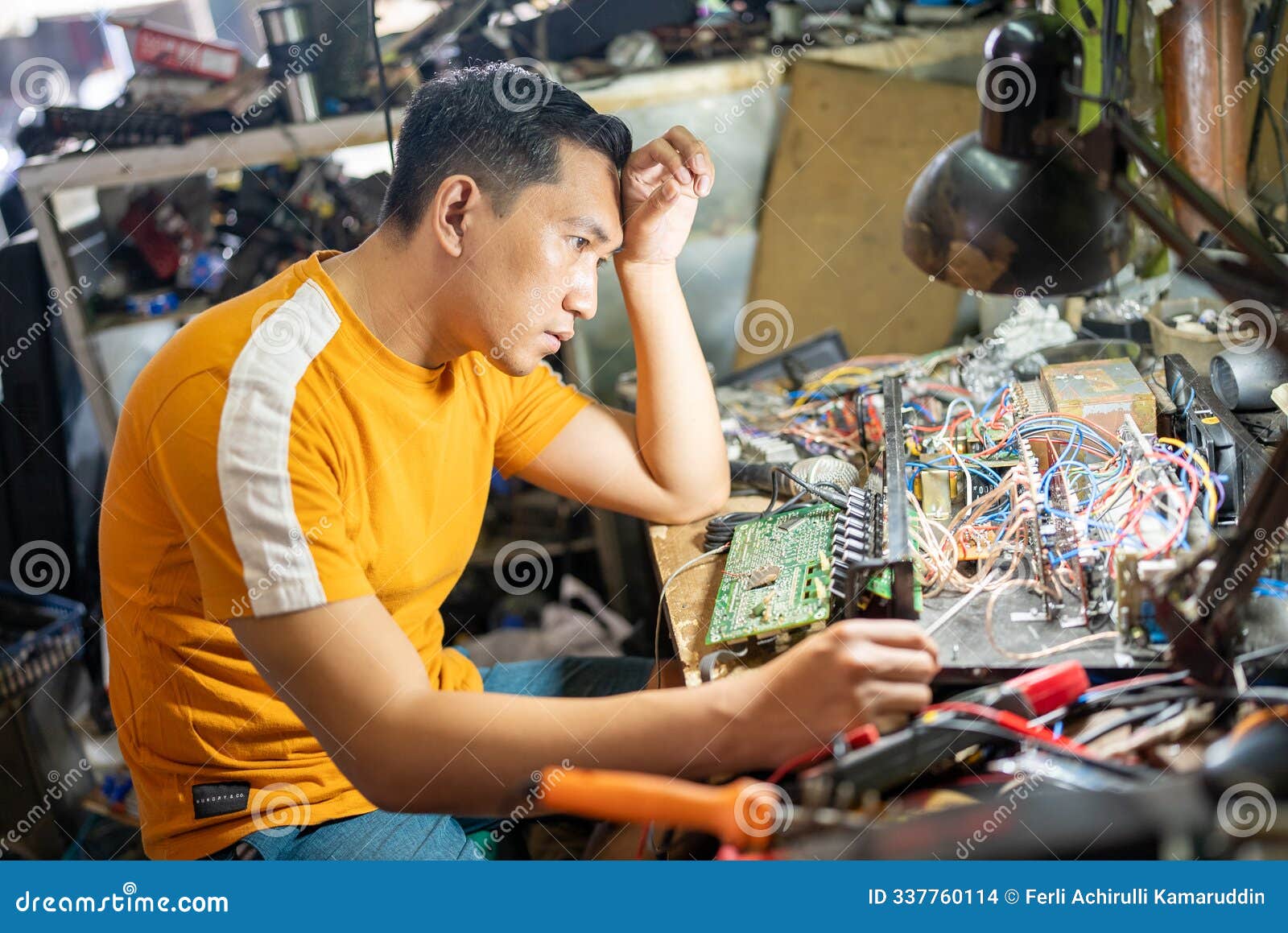 Technician Thinking Hard about the Complex Circuitry of an Electronic ...