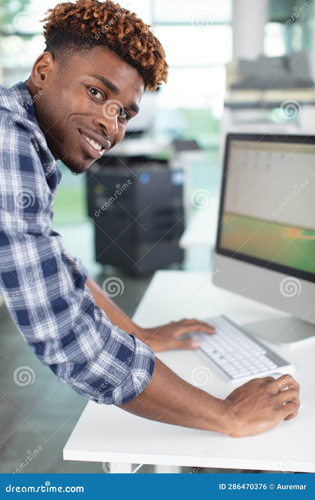 Technician Using Desktop Computer Smiles at Camera Stock Photo - Image ...