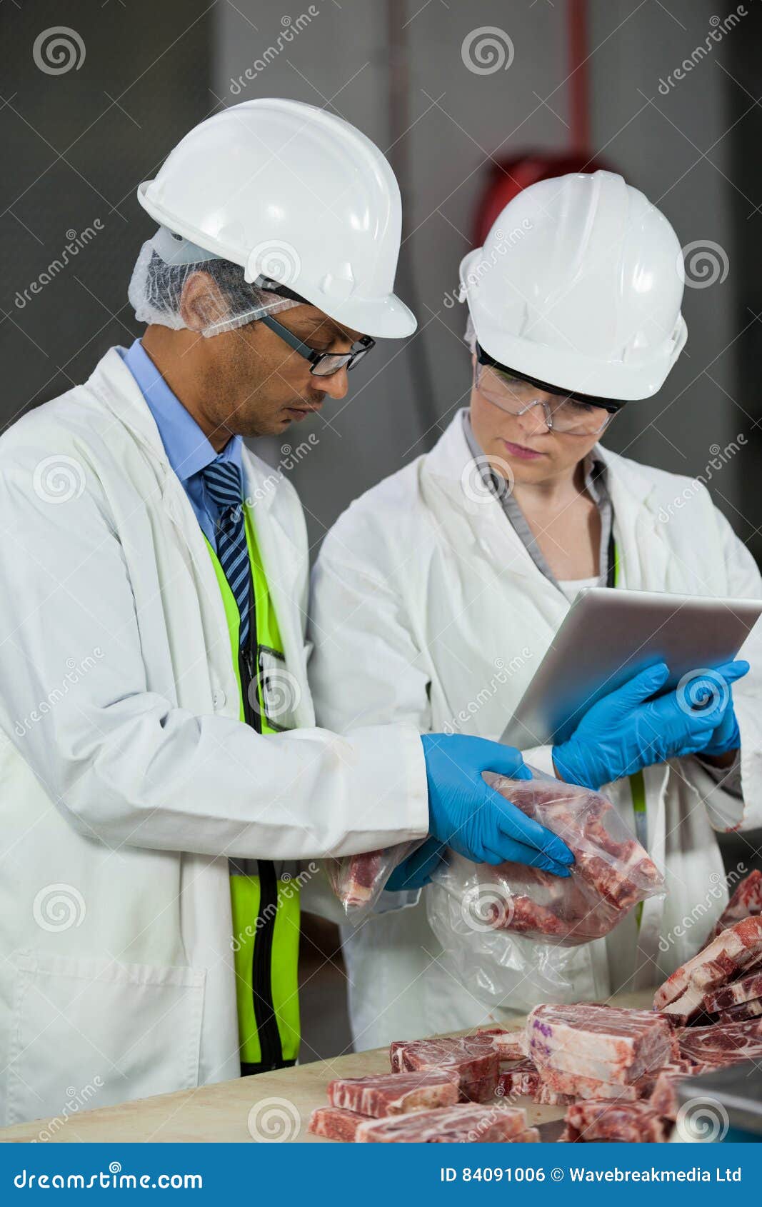 Technician Using Digital Tablet while Examining Meat Stock Photo ...