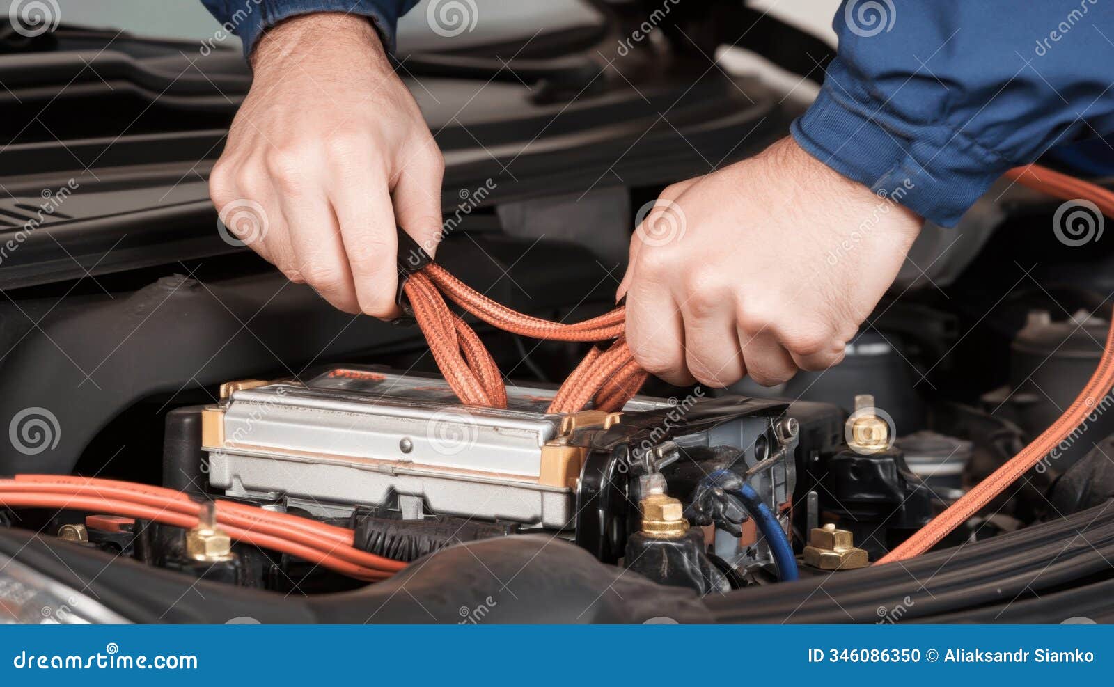 Technician Using Jumper Cables on a Car Battery Demonstrating ...
