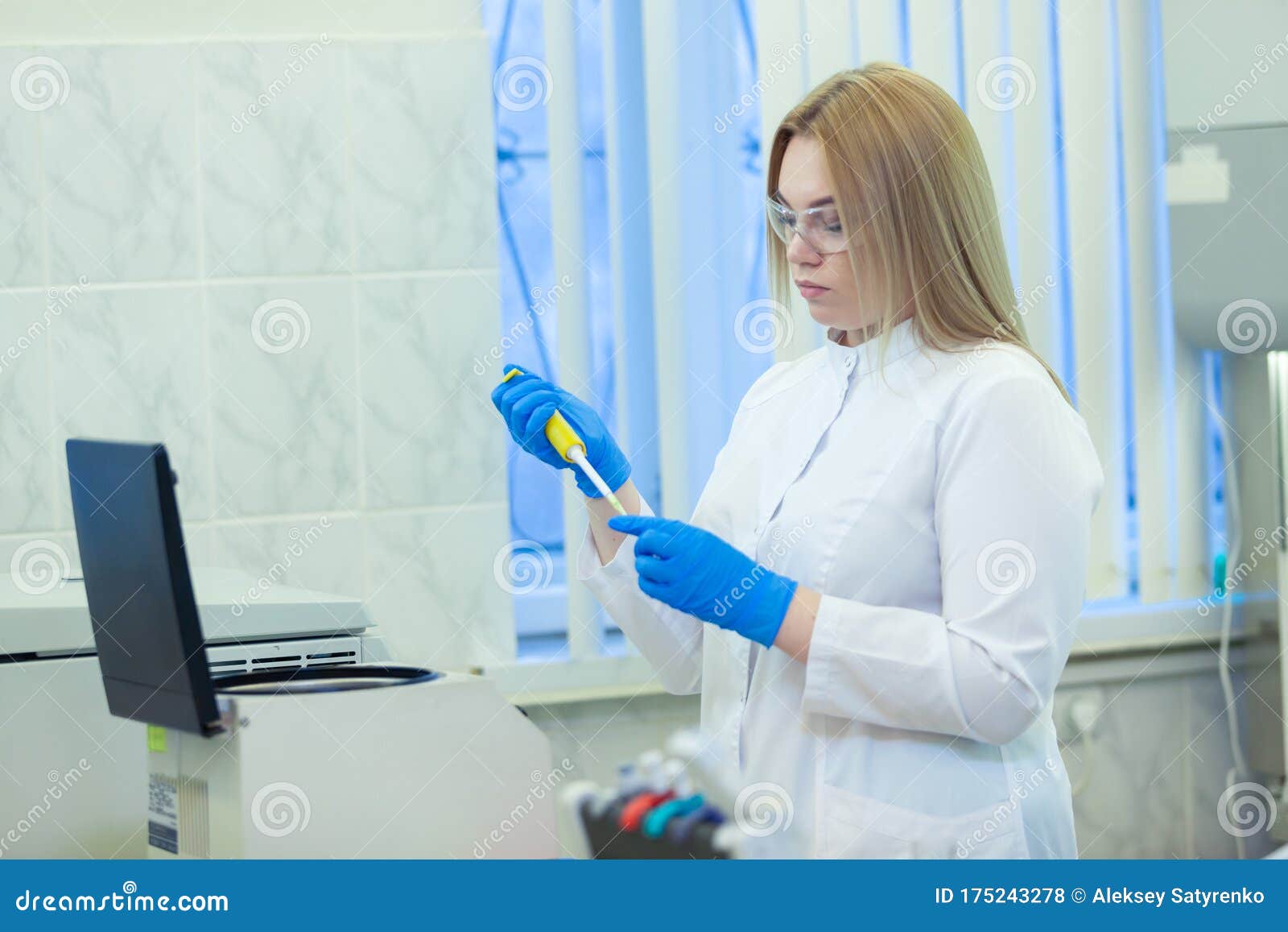 Technician Using Laboratory Pipette and Loading Samples To a Centrifuge ...
