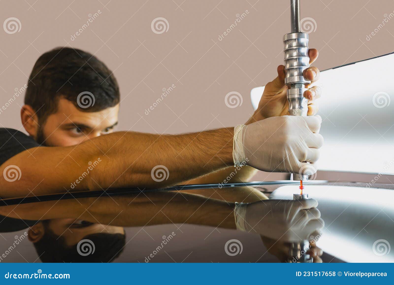 Technician Using Protective Gloves is in Process of Paintless Dent ...
