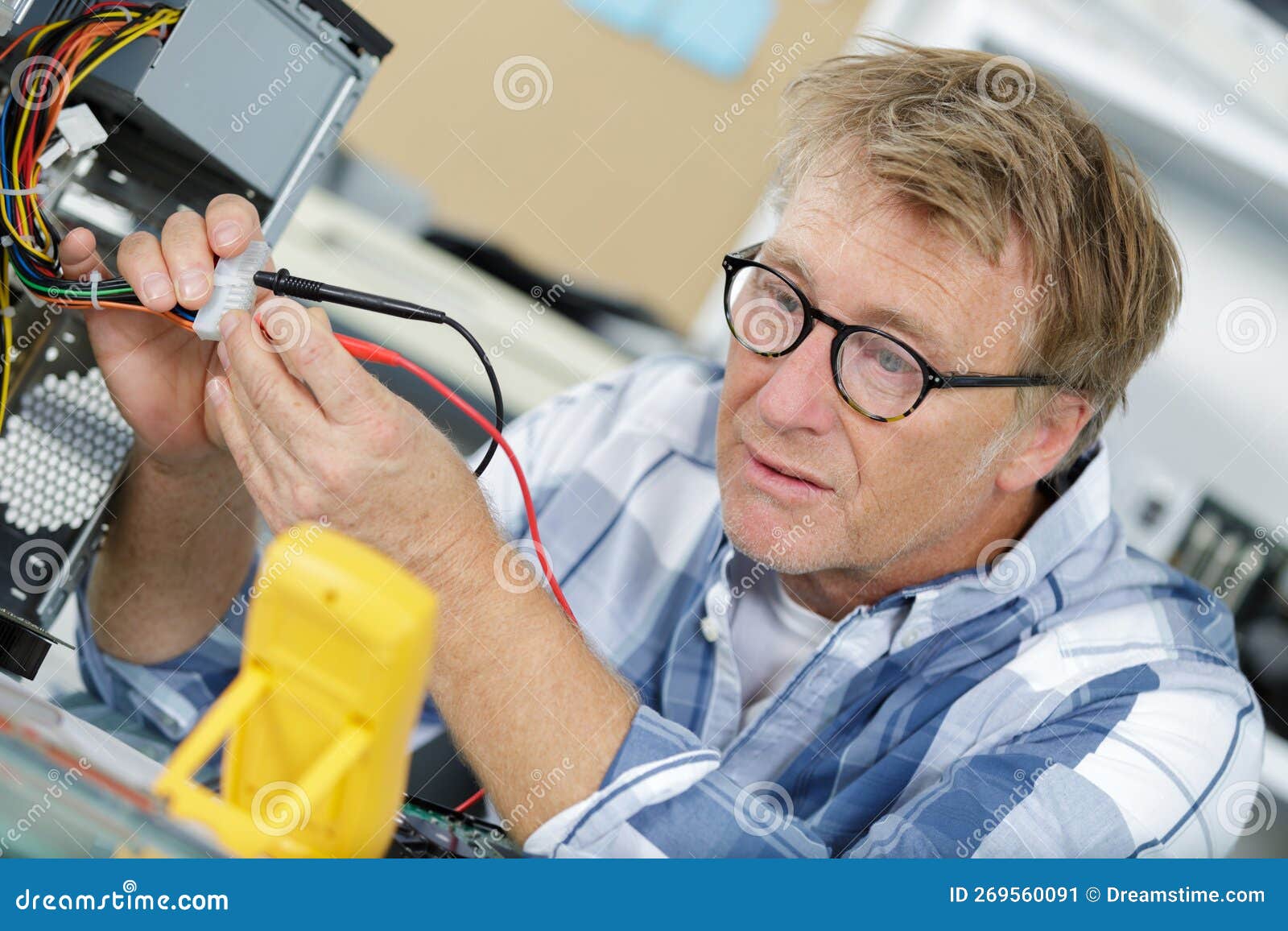 Technician Using Voltage Meter for Voltage Measurement in Computer ...