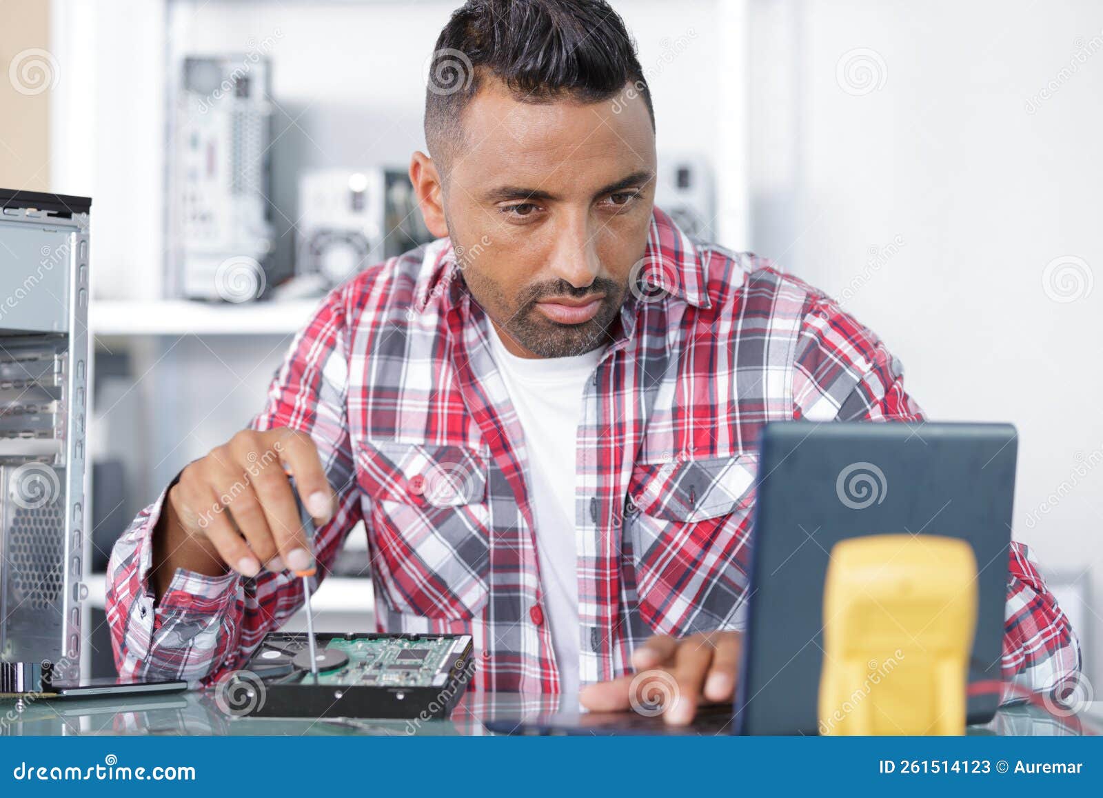 Technician Using Voltage Meter for Voltage Measurement in Computer ...