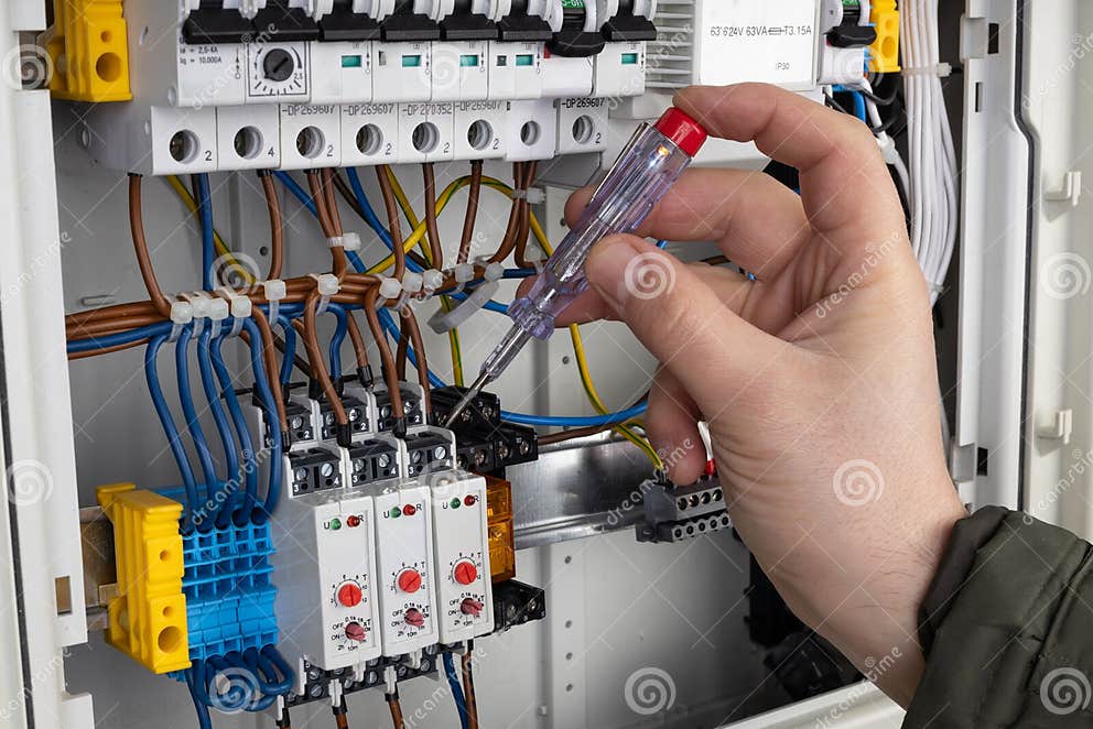 Technician Using Voltage Tester on Wiring Stock Photo - Image of ...
