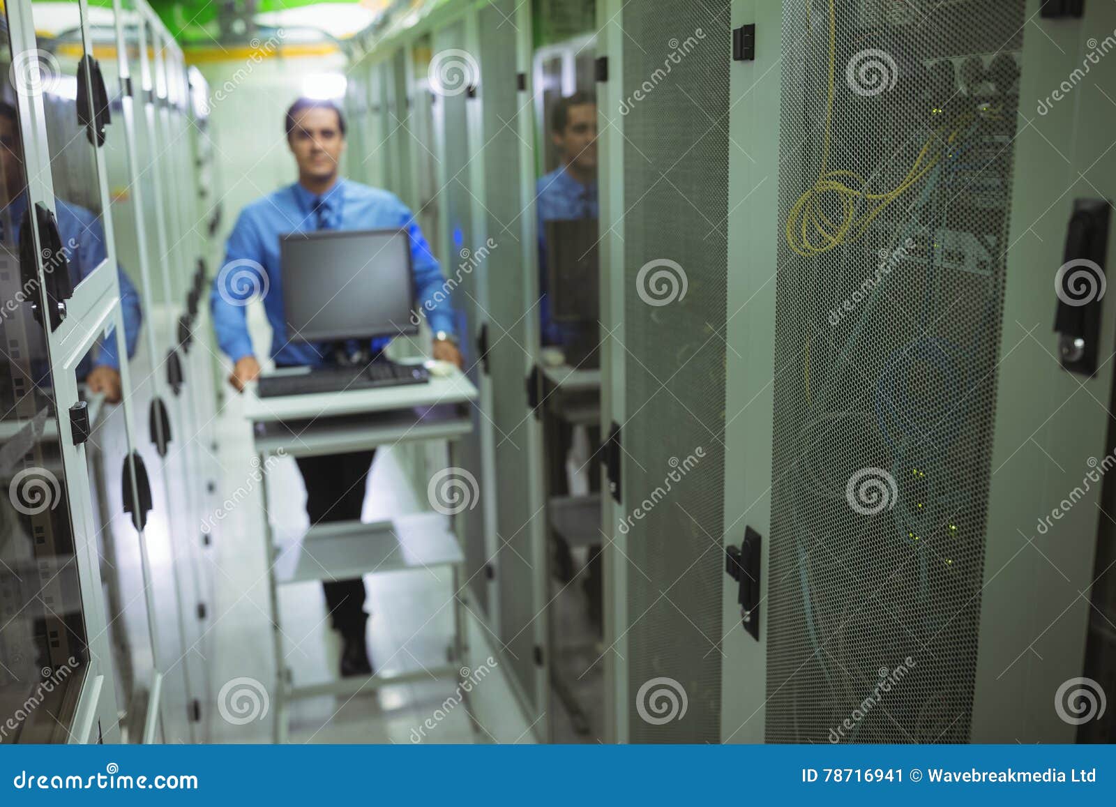 Technician Walking with Personal Computer in Hallway Stock Image ...