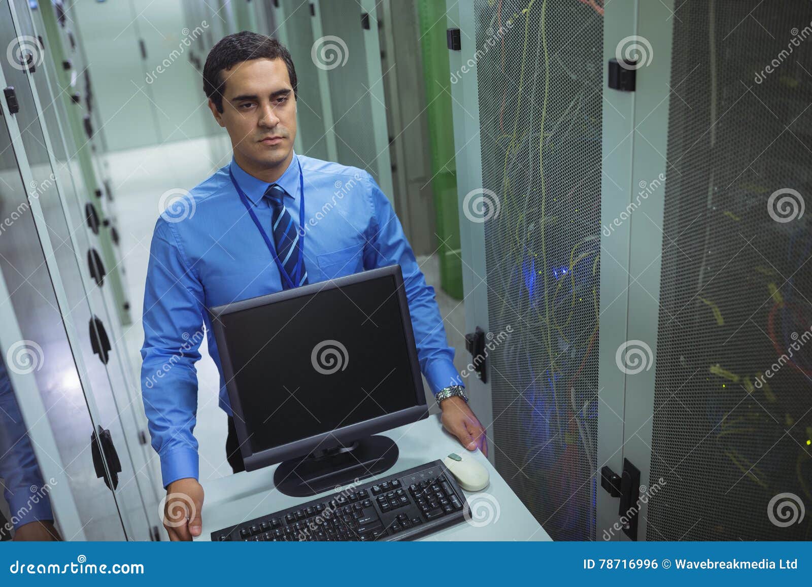 Technician Walking with Personal Computer in Hallway Stock Photo ...