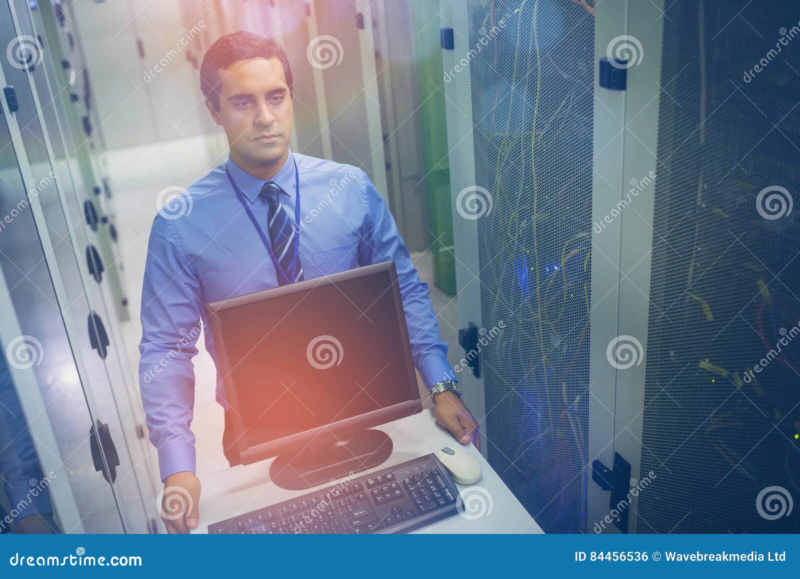 Technician Walking with Personal Computer in Hallway Stock Photo ...