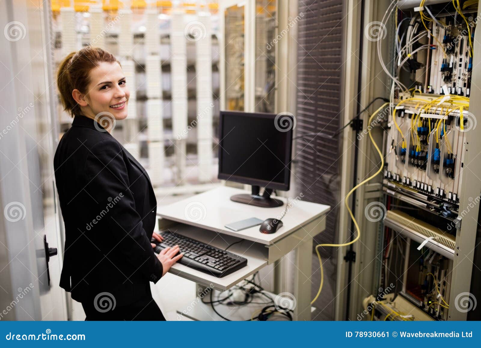 Technician Working on Computer while Analyzing Server Stock Image ...
