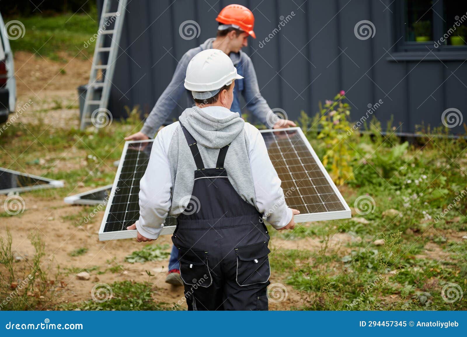Technicians Carrying Photovoltaic Solar Module while Installing Solar ...