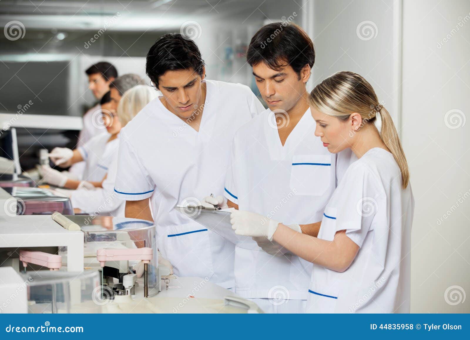 Technicians Discussing Over Clipboard Stock Photo - Image of female ...