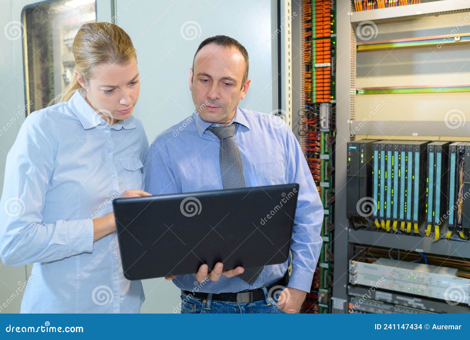 Technicians Discussing Over Laptop in Server Room Stock Photo - Image ...