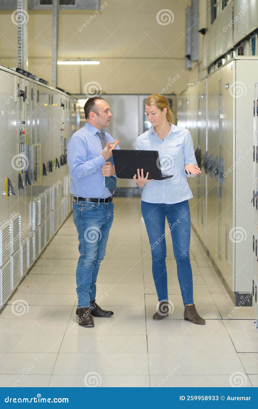 Technicians Discussing Over Laptop in Server Room Stock Image - Image ...