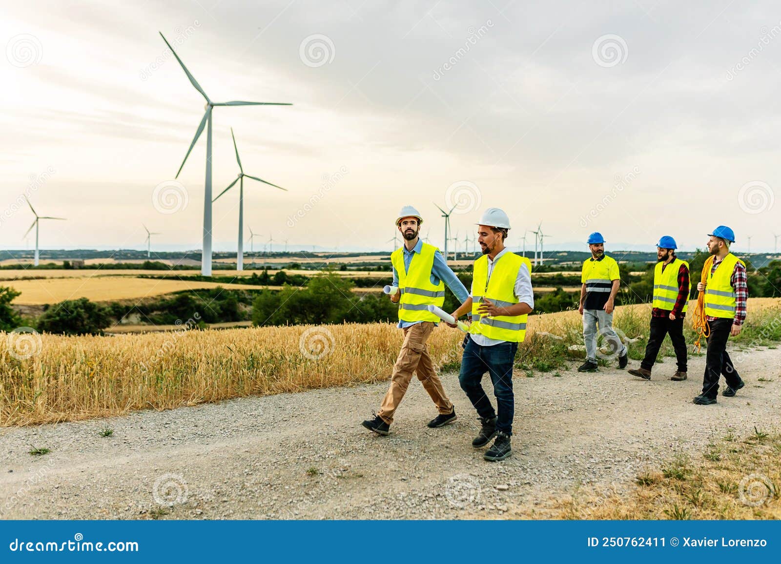 Technicians and Engineers Walking on a Field Path at a Wind Farm Stock ...