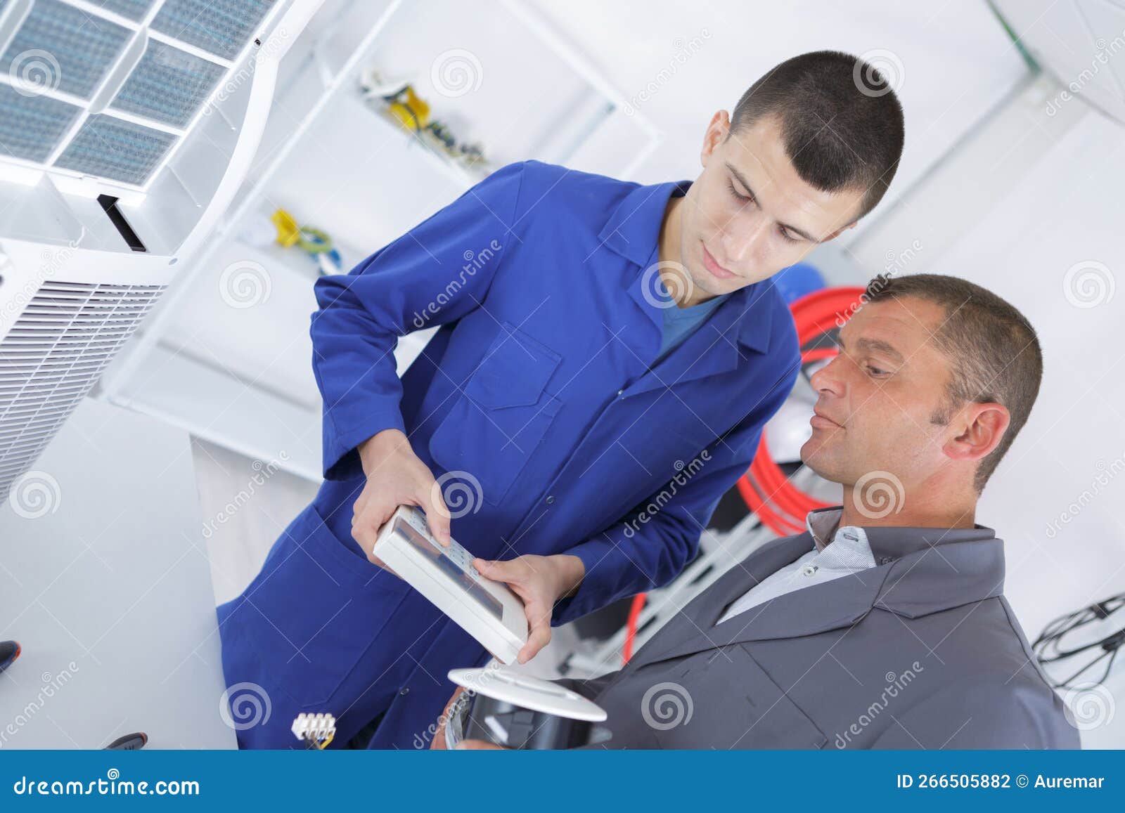 Technicians Operating Remote Control for Air Conditioning Unit Stock ...