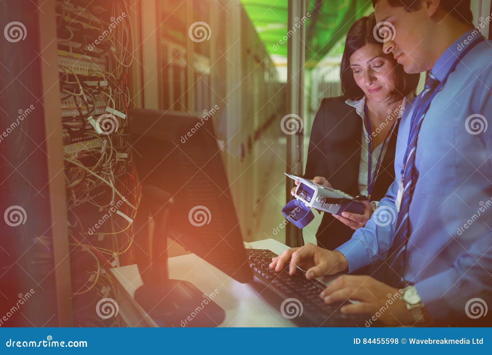 Technicians Using Digital Cable Analyzer while Working on Personal ...