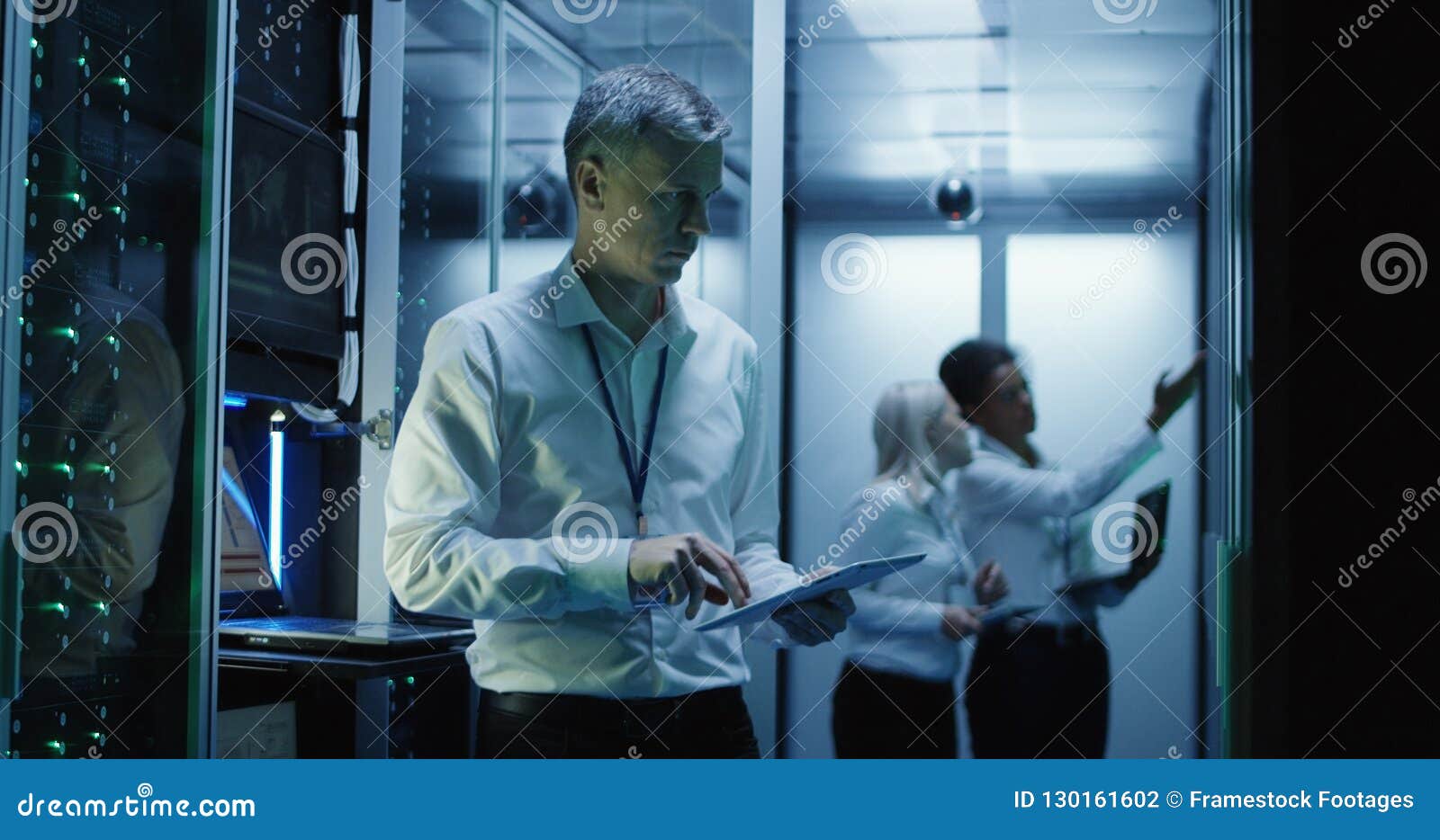 Technicians Work on a Laptop in a Data Center Stock Photo - Image of ...