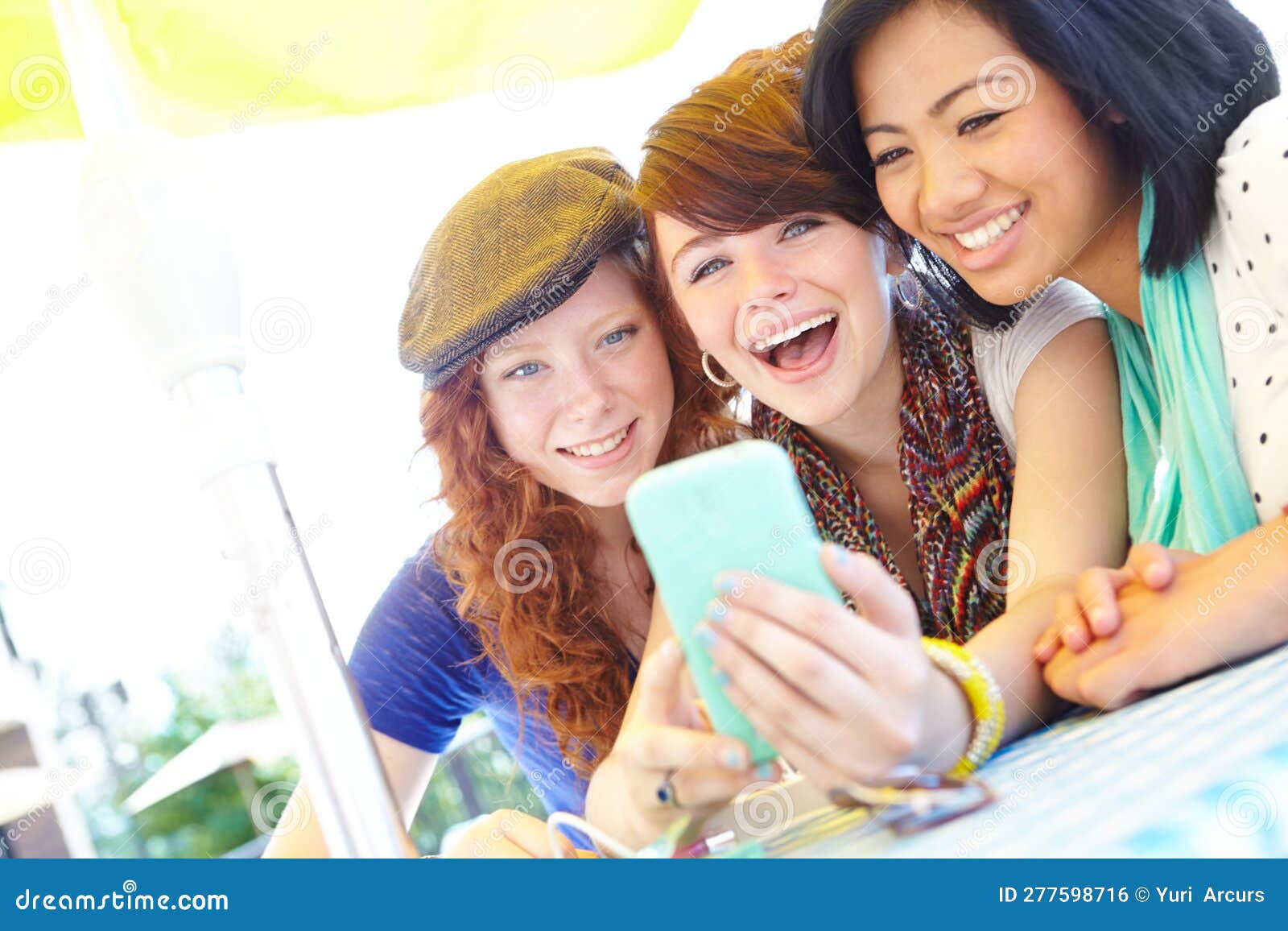Technological Fun. a Group of Adolescent Girls Laughing As they Look at ...