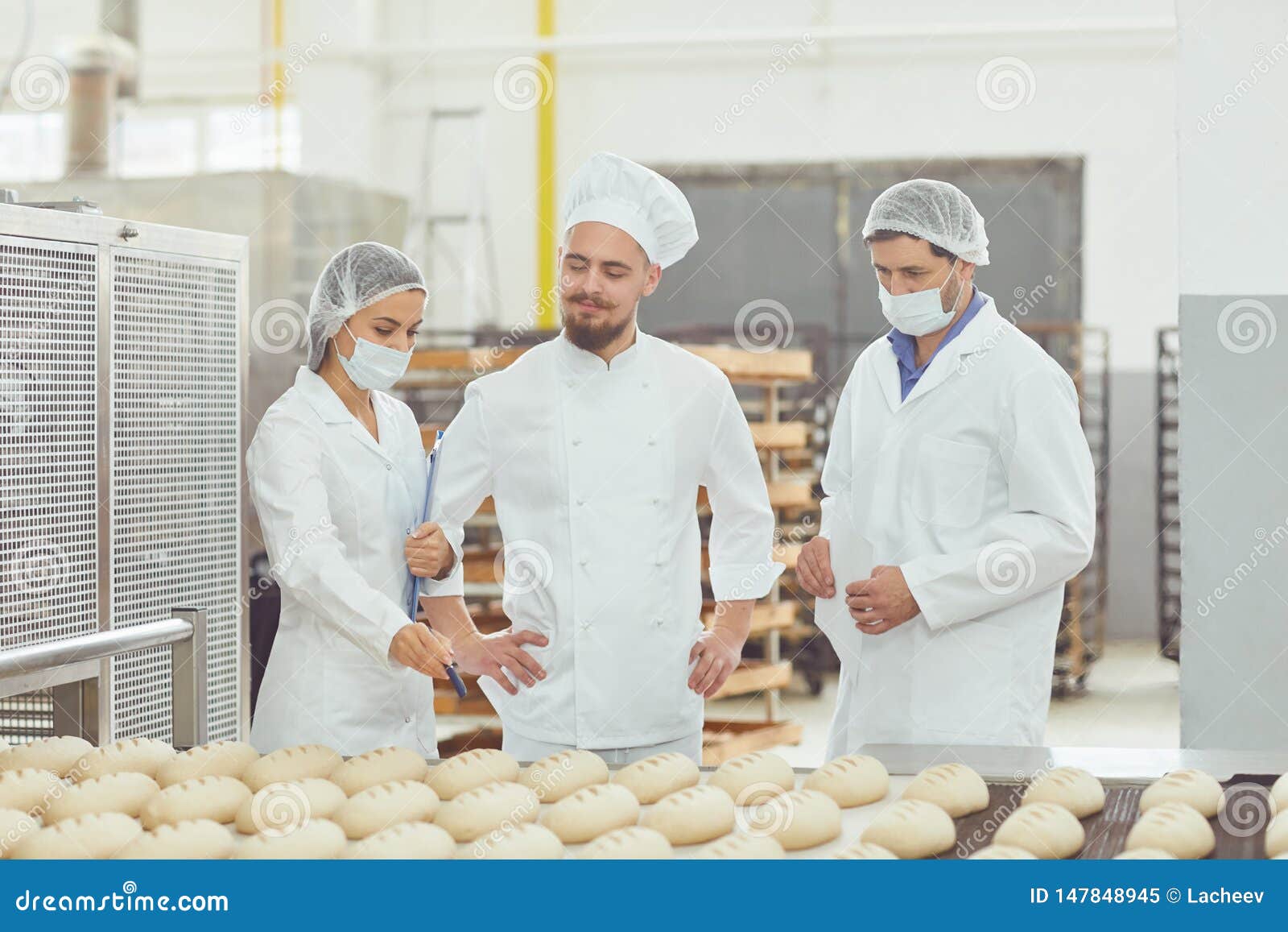 Technologist and Baker Inspect the Bread Production Line at the Bakery ...