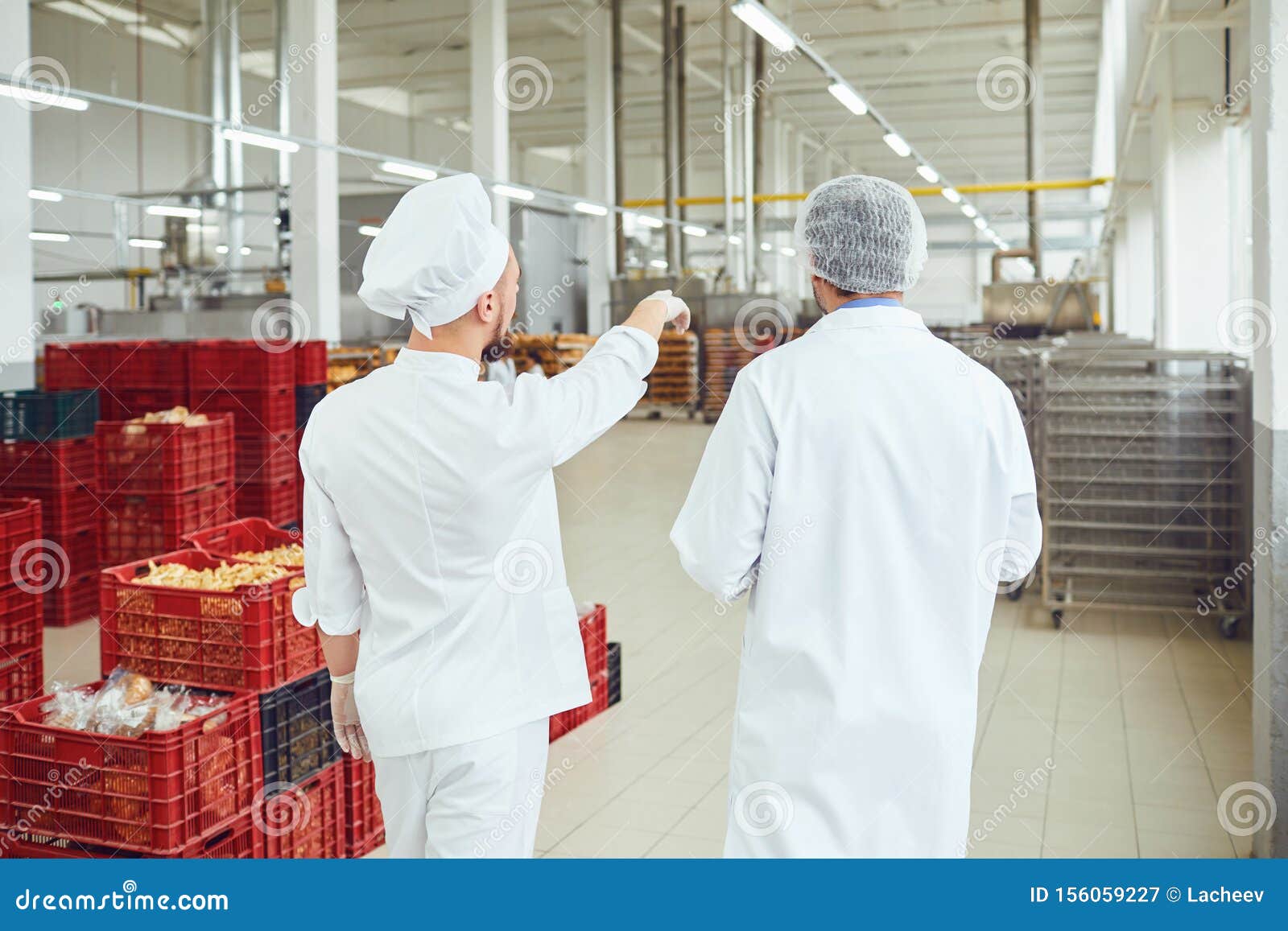 The Technologist and Baker Speak in a Bread Factory. Stock Image ...