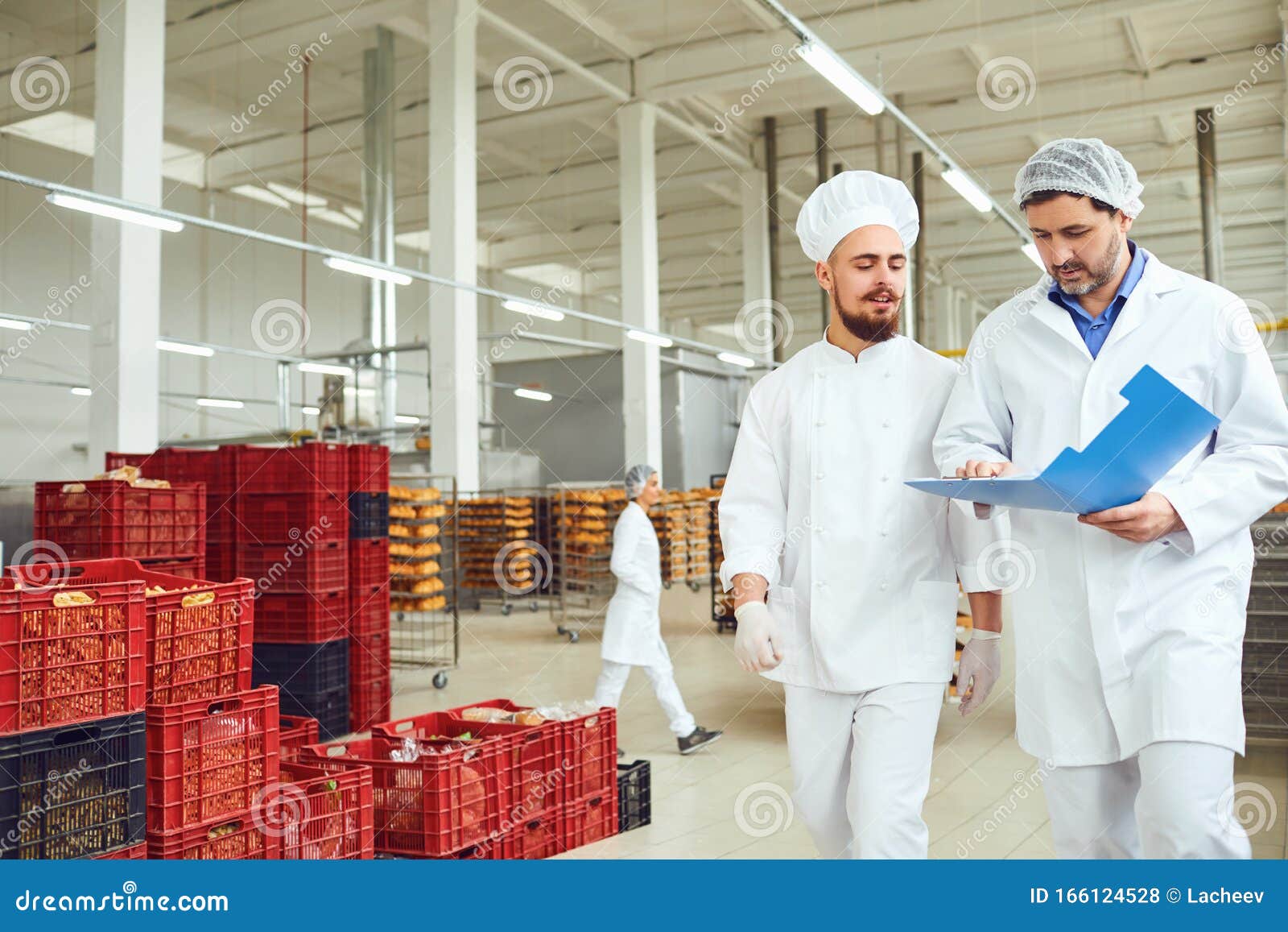 The Technologist and Baker Speak in a Bread Factory. Stock Photo ...