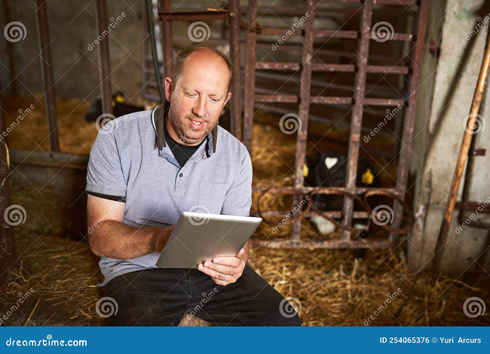 Technology Can Help in Any Industry. a Male Farmer Using a Tablet while ...