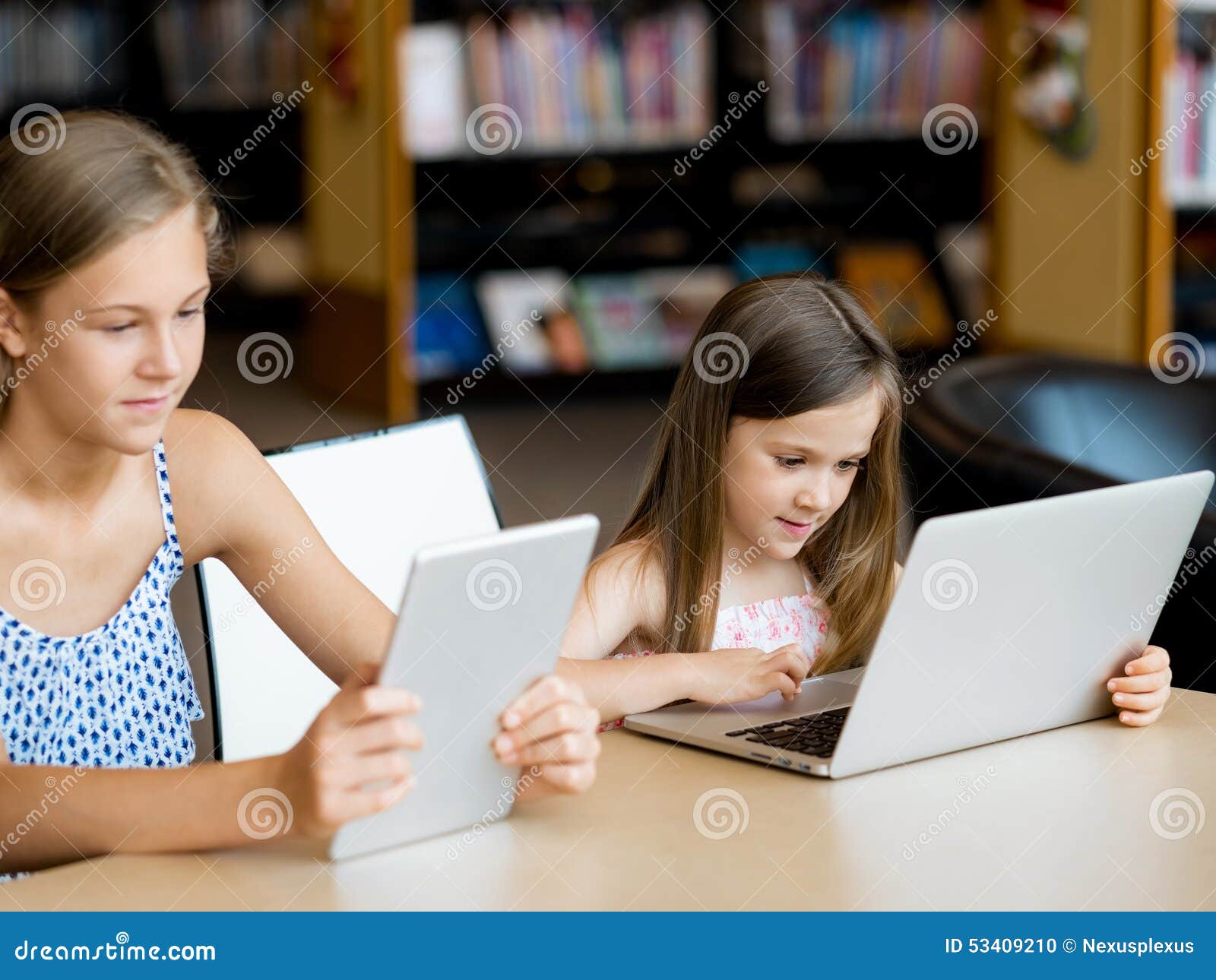 Technology and Fun in the Library Stock Photo - Image of pretty, people ...