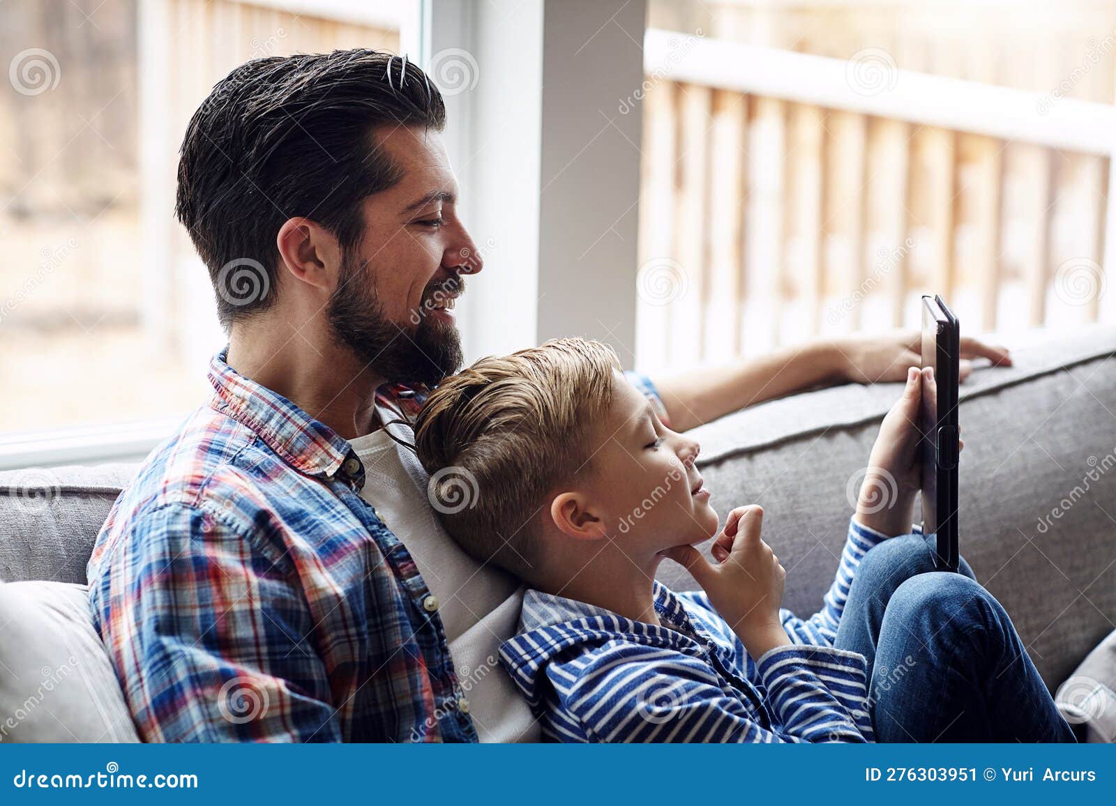 Technology Keeps Them Curious. a Little Boy Using a Digital Tablet with ...