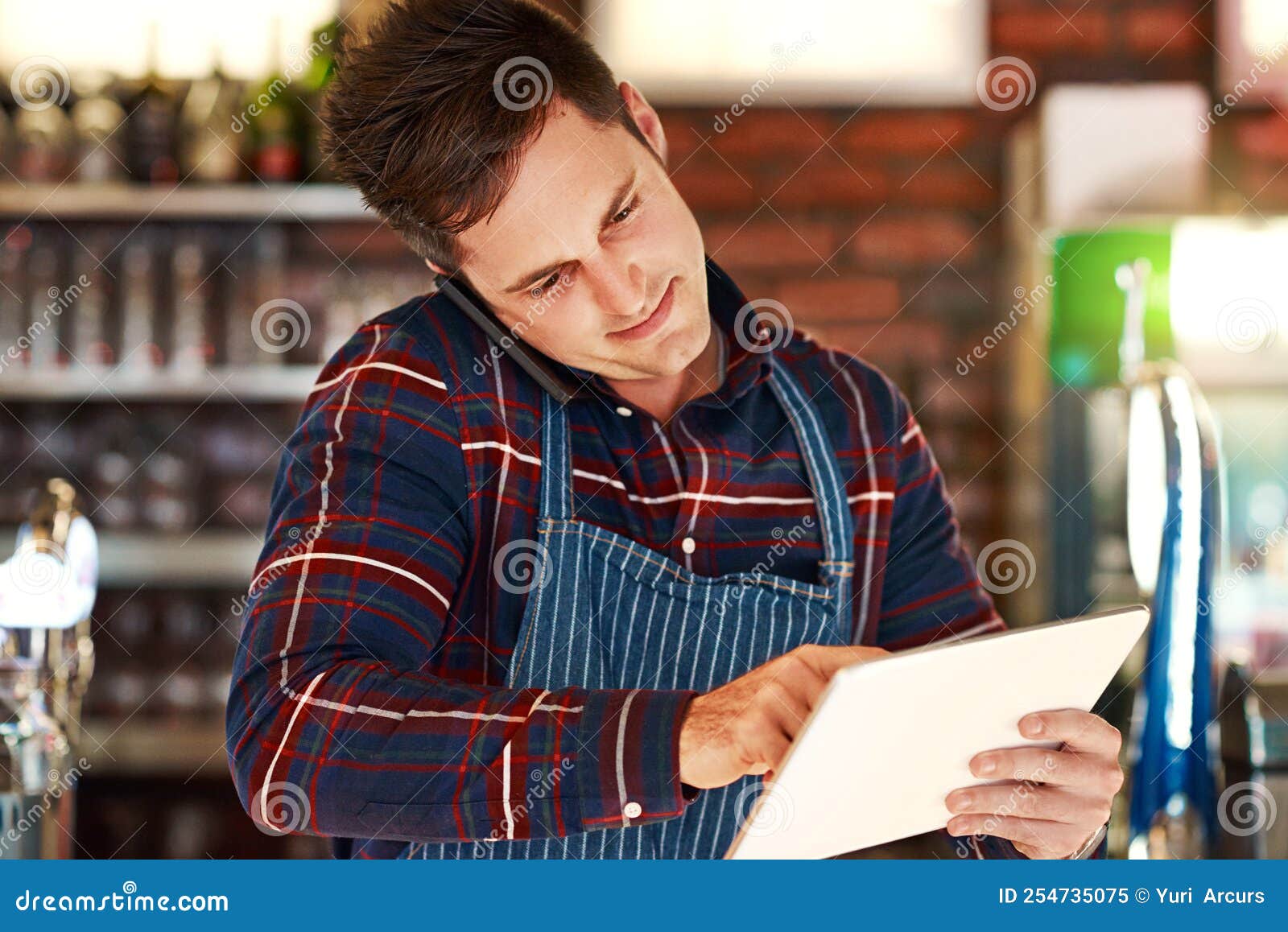 Technology Makes it Look so Easy. a Restaurant Owner Talking on His ...