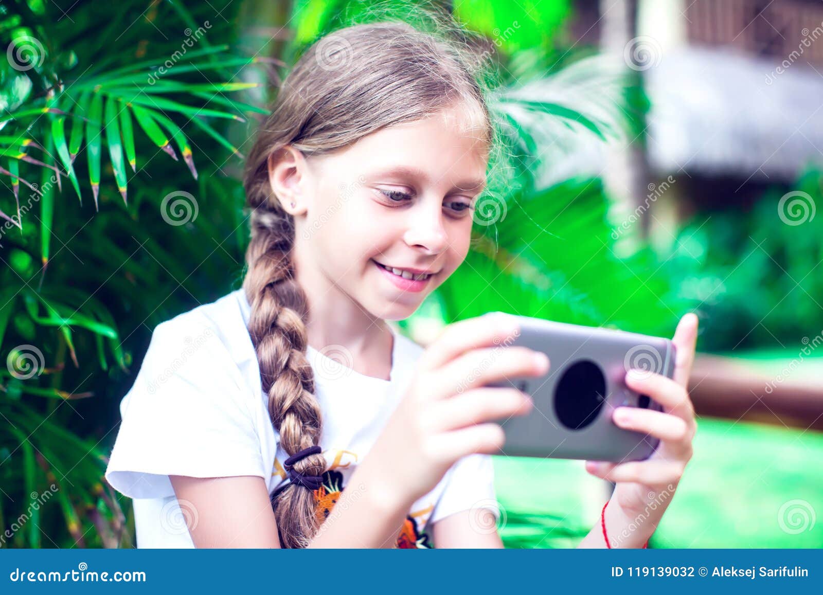 Technology and People Concept - Happy Smiling Girl Using Smartphone ...