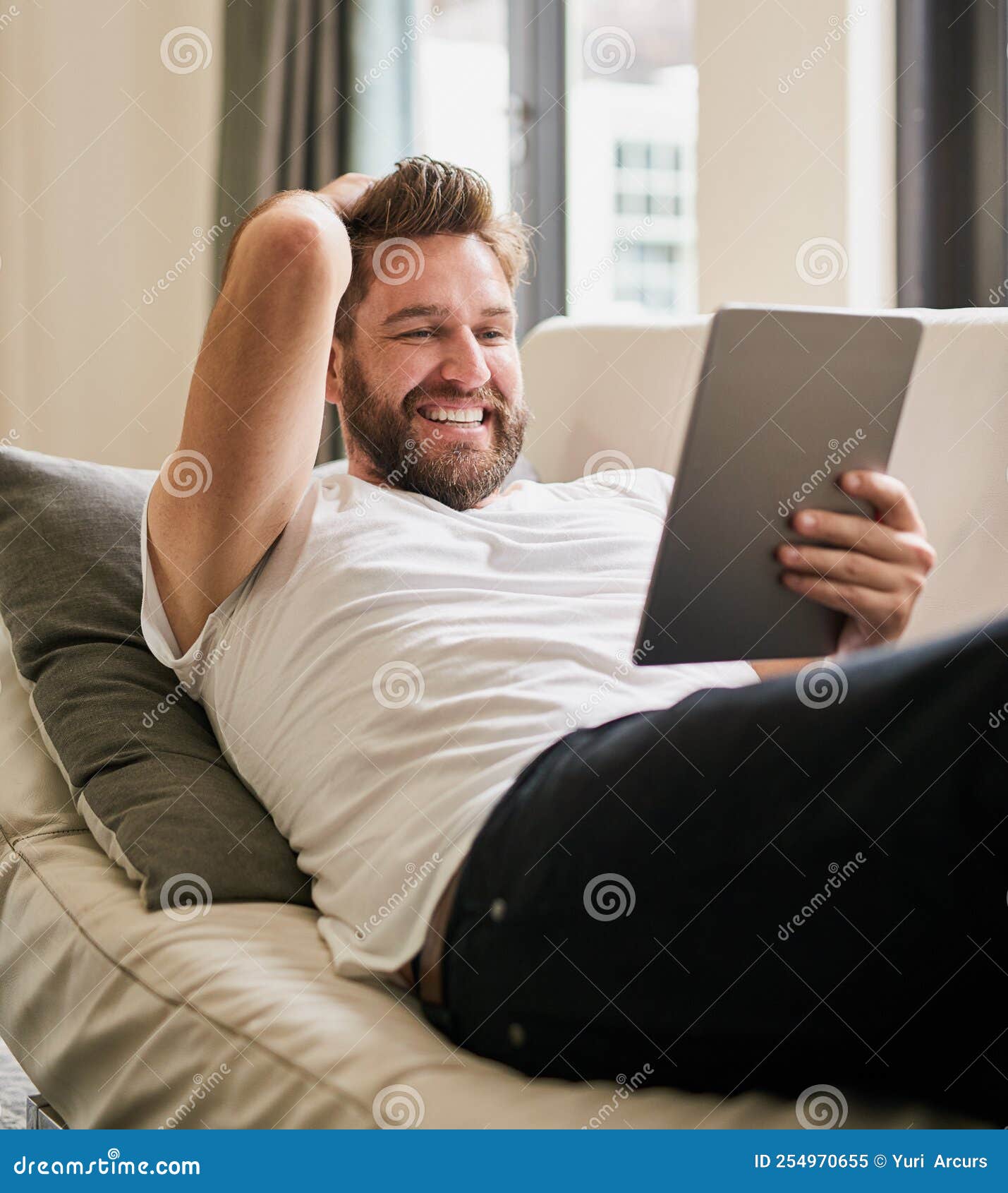 Technologys Got His Weekend Covered. a Young Man Using a Digital Tablet ...