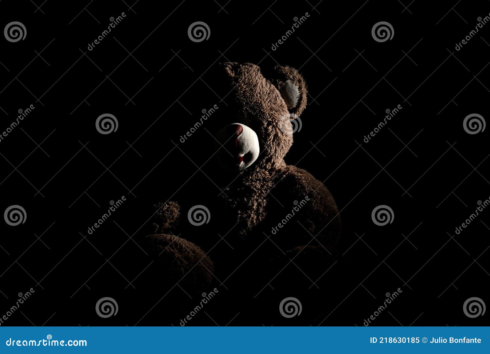 Teddy bear in the darkness stock image. Image of color - 218630185