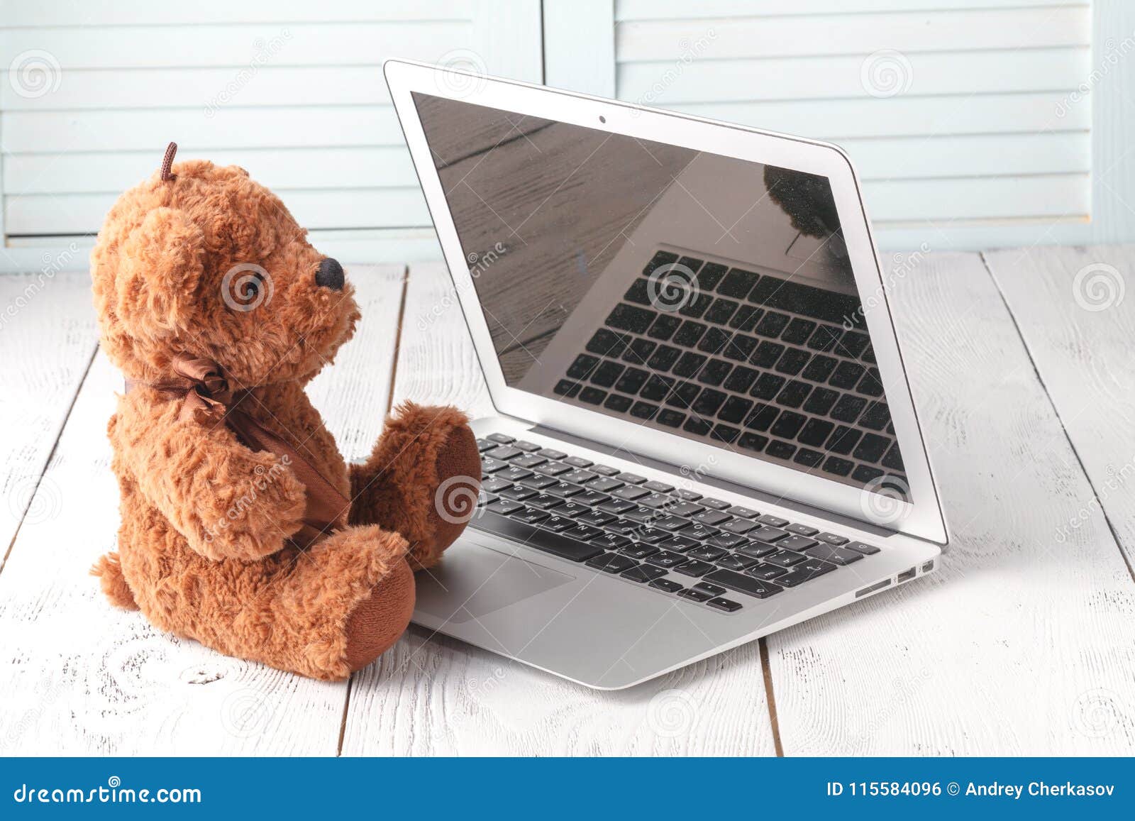 Teddy Bear and Modern Silver Laptop Stock Photo - Image of ...