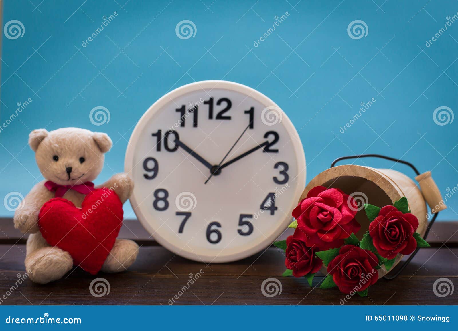Teddy Bear With Pink Heart And Clock Decoration On Wooden Table Stock
