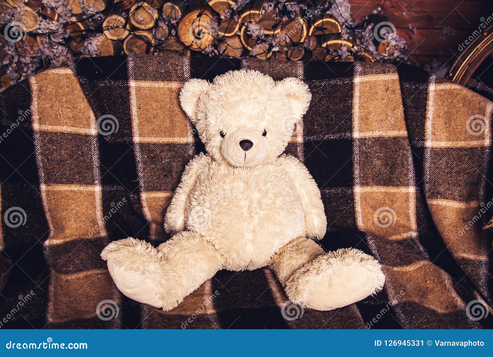 Teddy bear sits on couch. stock image. Image of furry - 126945331