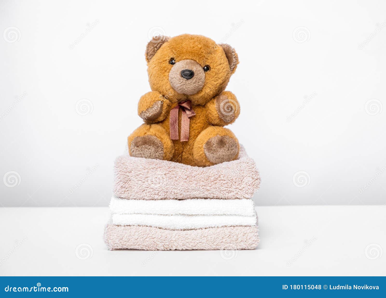 Teddy Bear and a Stack of Clean and Fresh Cotton Towels Stock Photo ...