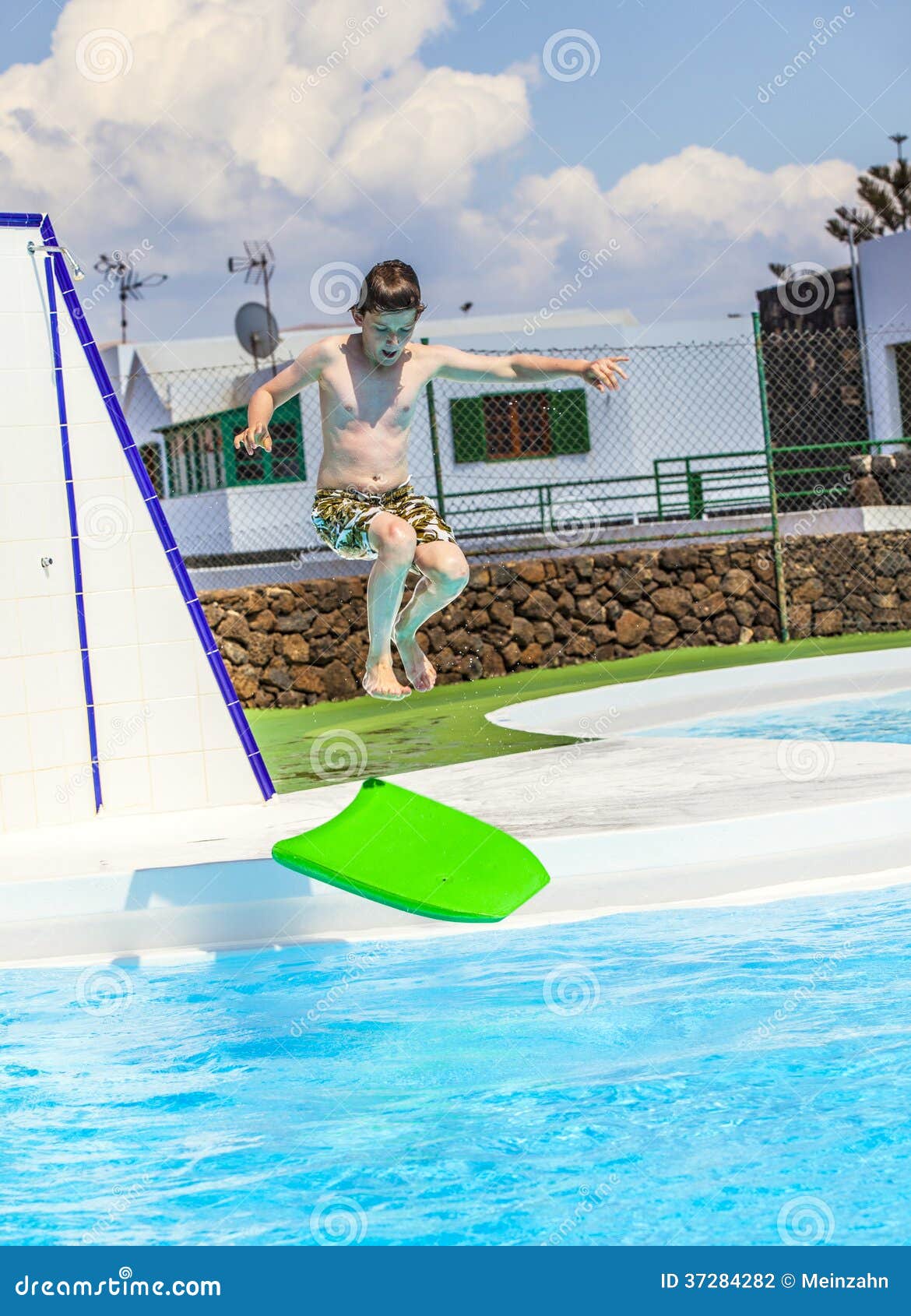 Teen Boy Jumps into the Pool with His Boogie Board Stock Photo - Image ...