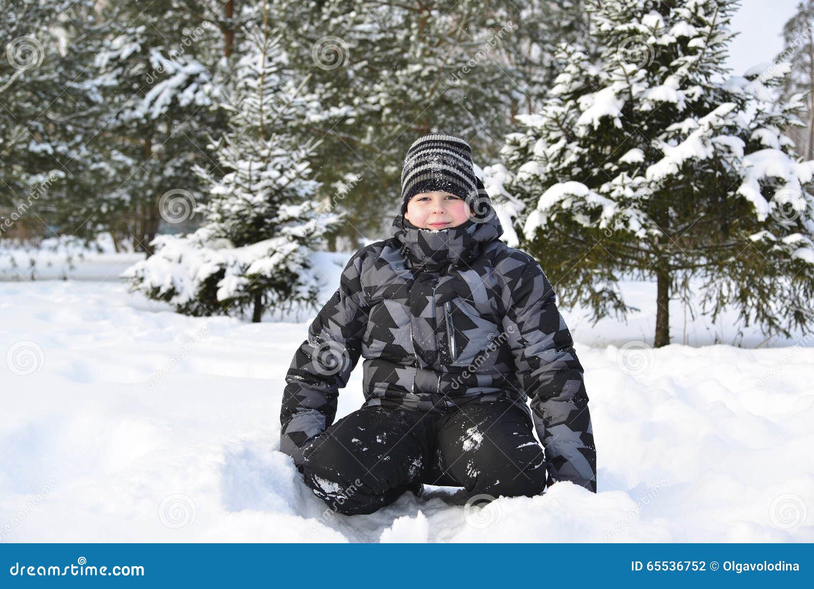 Teen Boy Sitting on Snow in the Winter Forest Stock Photo - Image of ...