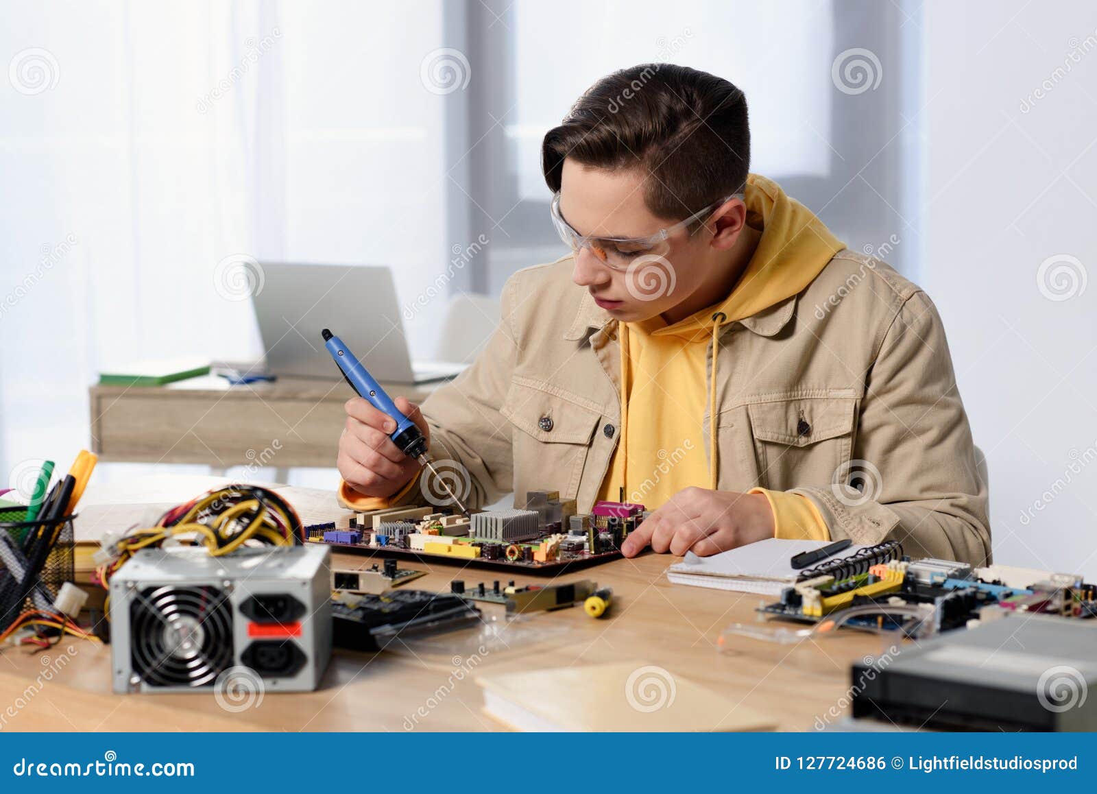 Teen Boy Soldering Computer Motherboard with Soldering Iron Stock Photo ...