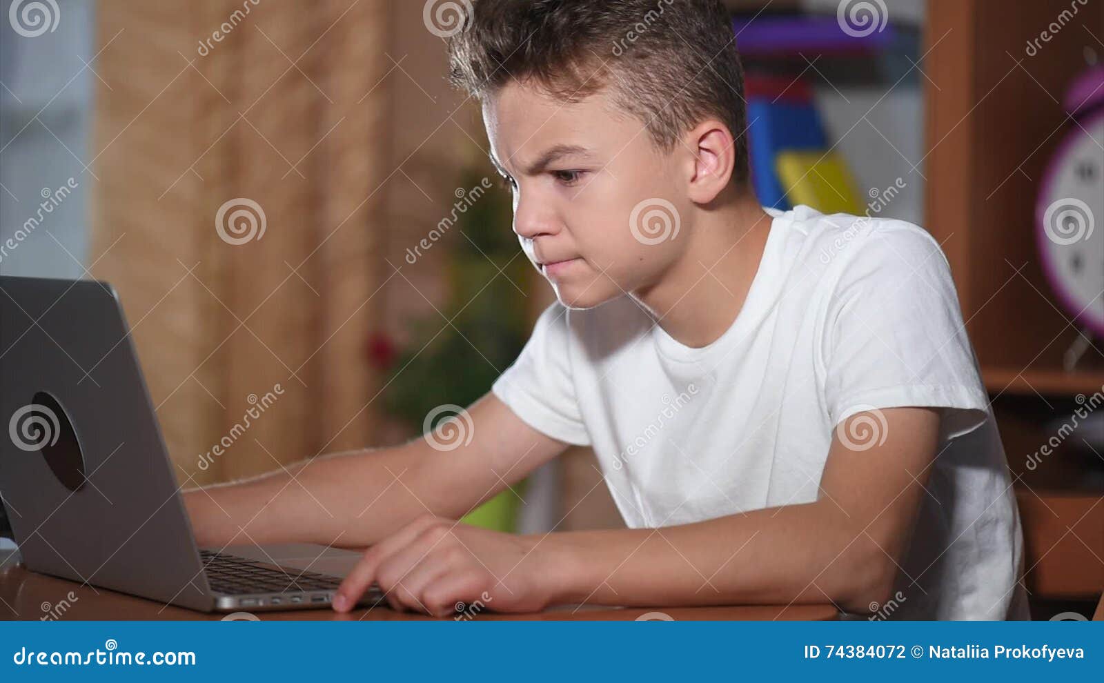 Teen boy working on laptop stock footage. Video of clicking - 74384072