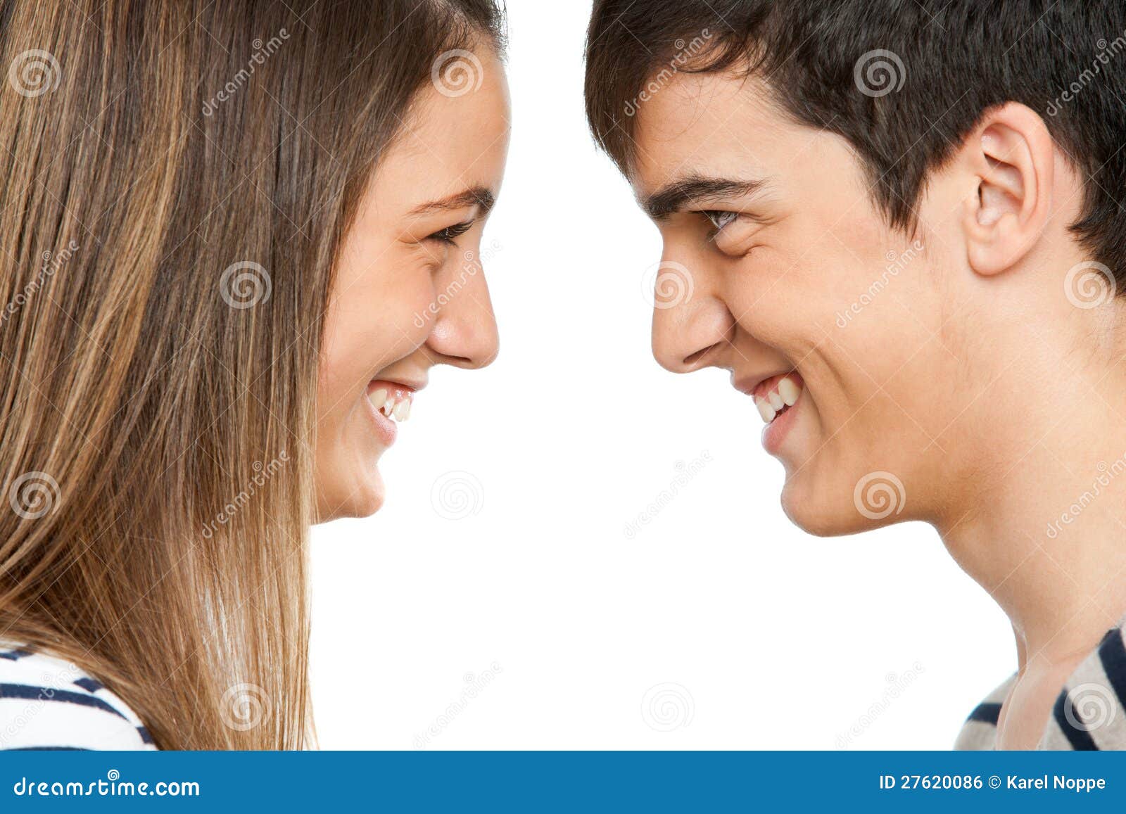 Teen Couple Facing Each Other Smiling. Stock Photo - Image of message ...