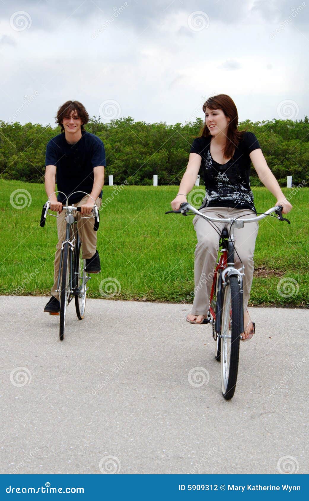 Teen couple riding bikes stock photo. Image of date, enjoyment - 5909312