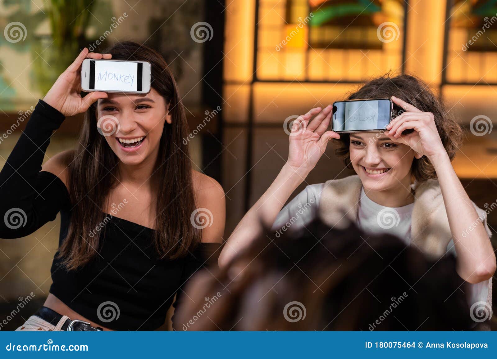 Teen Friends Having Fun Playing in a Cafe. Friends Activity Concept ...