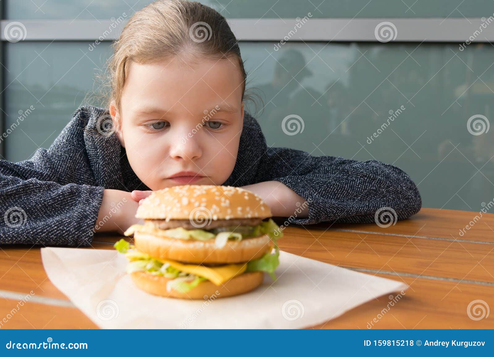 Teen Girl Looking at Appetizing Burger Lying in Front of Her on the ...